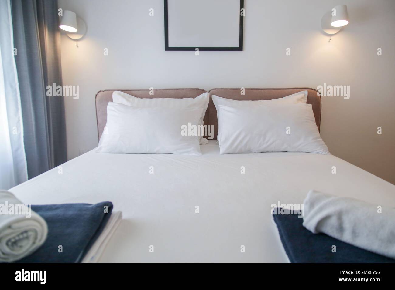 King size bed in simple and cozy bedroom Stock Photo - Alamy