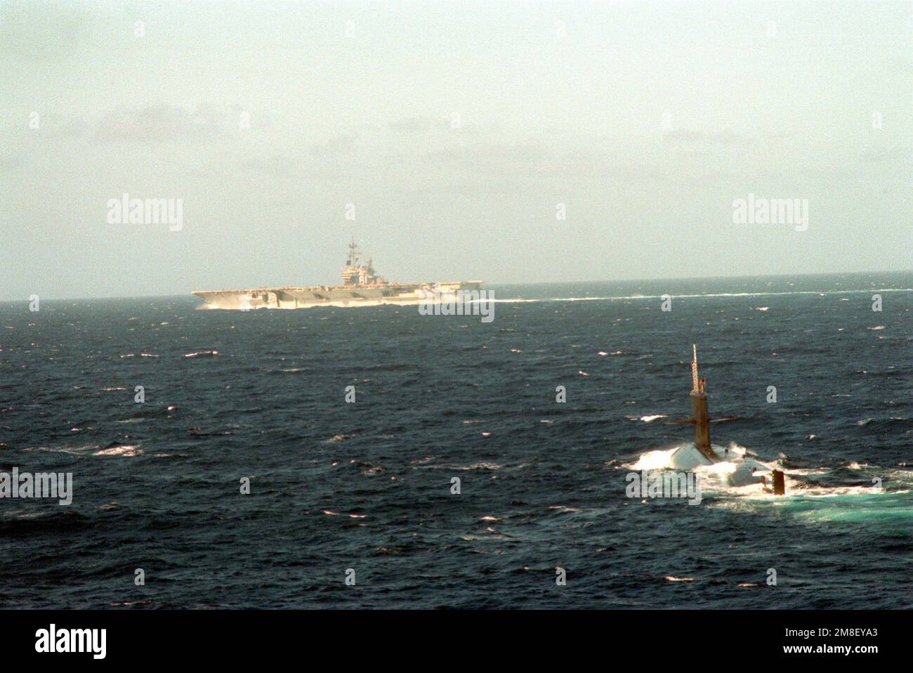 A Sturgeon class submarine approaches the aircraft carrier USS RANGER ...