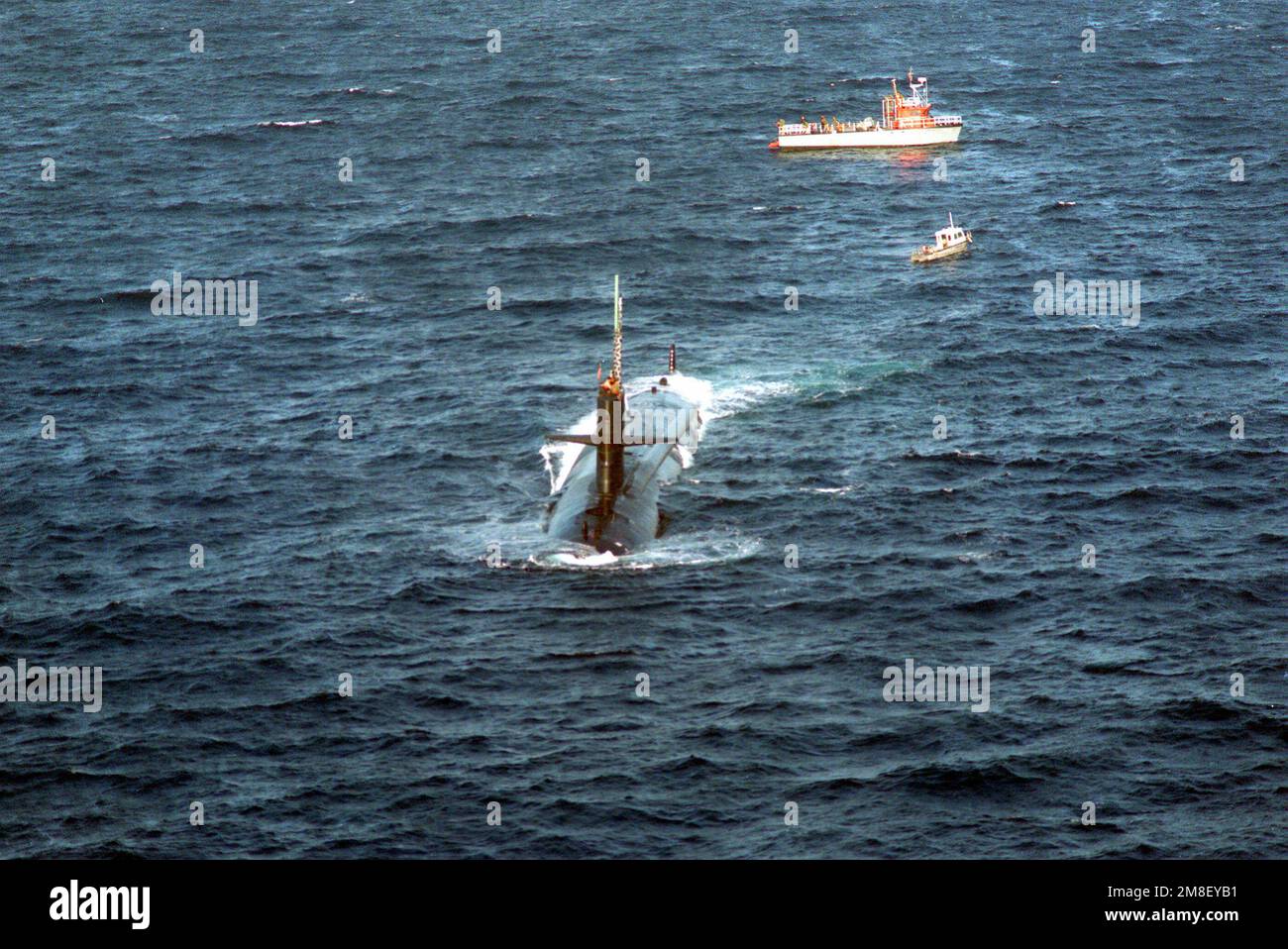 A bow view of a Sturgeon class submarine underway on the surface, with ...