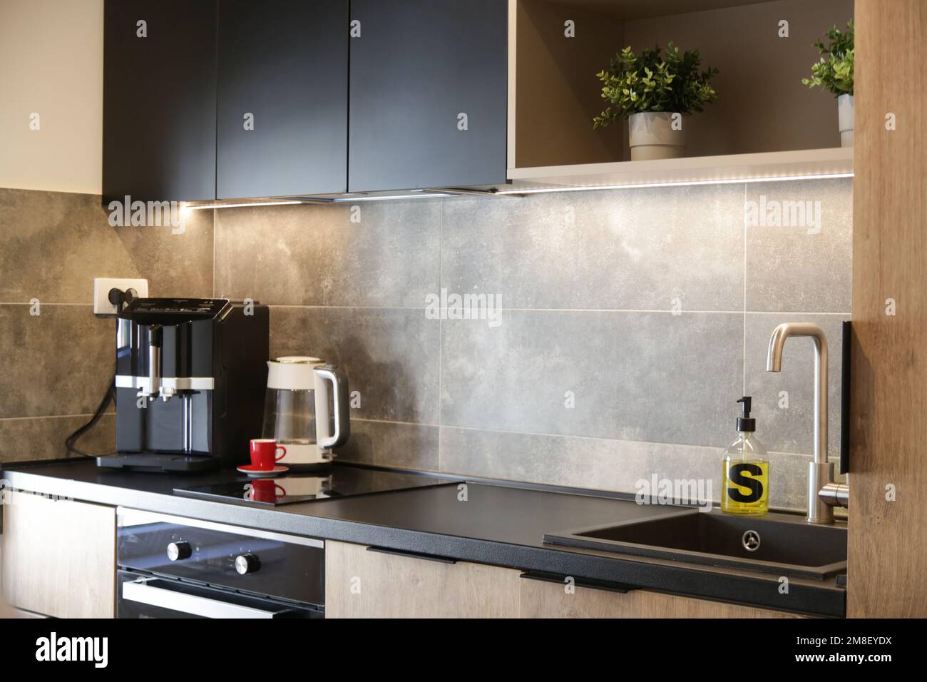 Coffee maker and electric tea kettle on the kitchen counter, modern ...