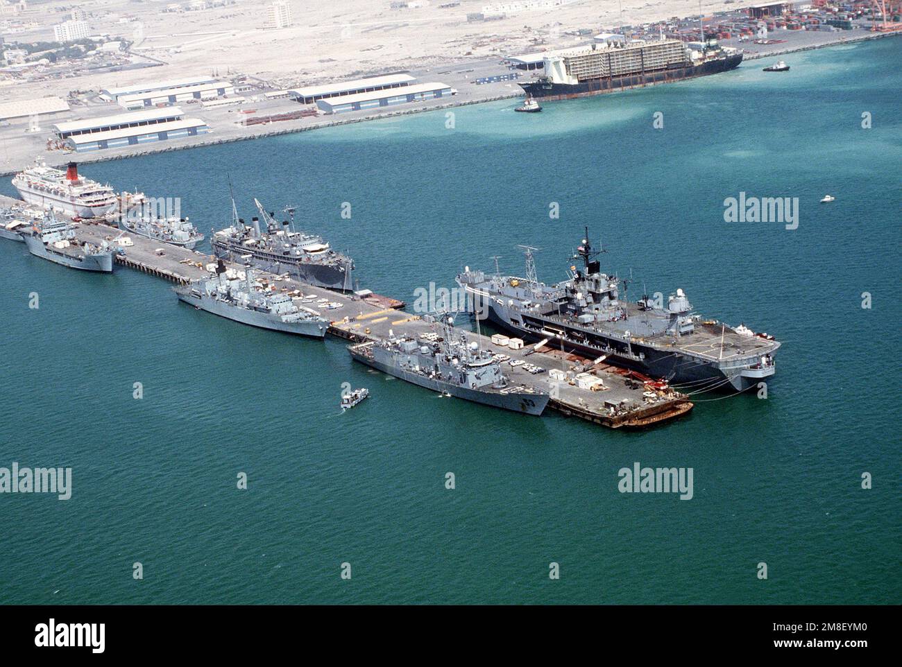 The amphibious command ship USS BLUE RIDGE (LCC-19), right foreground ...
