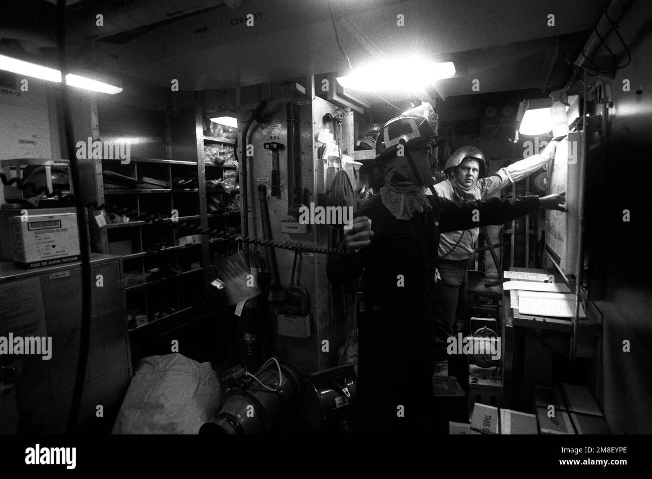A sailor checks a control board in the No. 3 repair locker during a ...