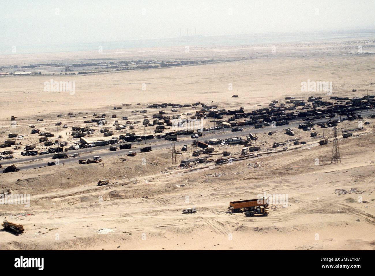 Demolished and abandoned vehicles line the highway en route to Basra in ...