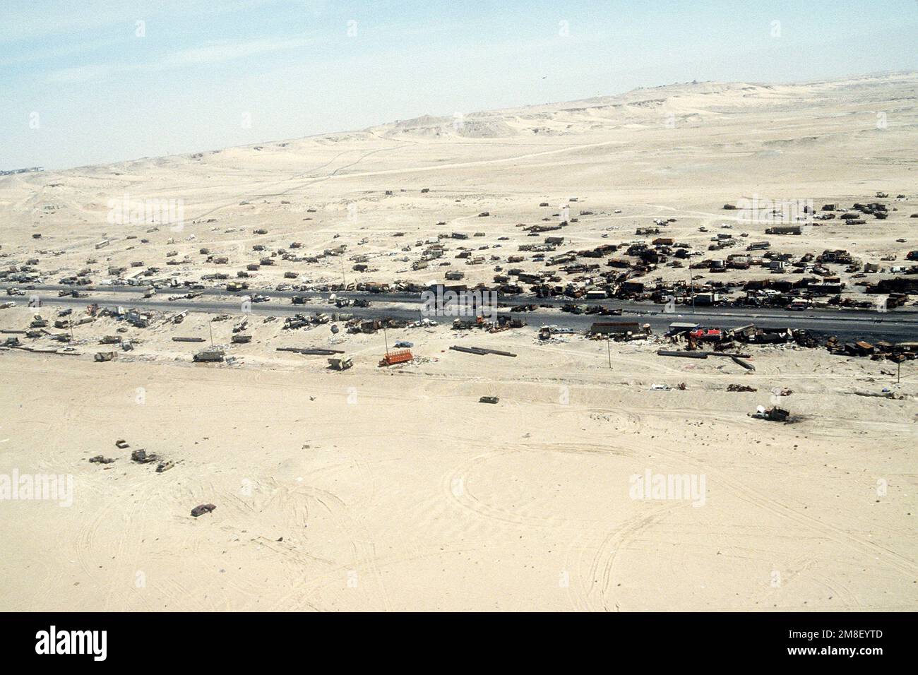 Demolished and abandoned vehicles line the highway en route to Basra in ...