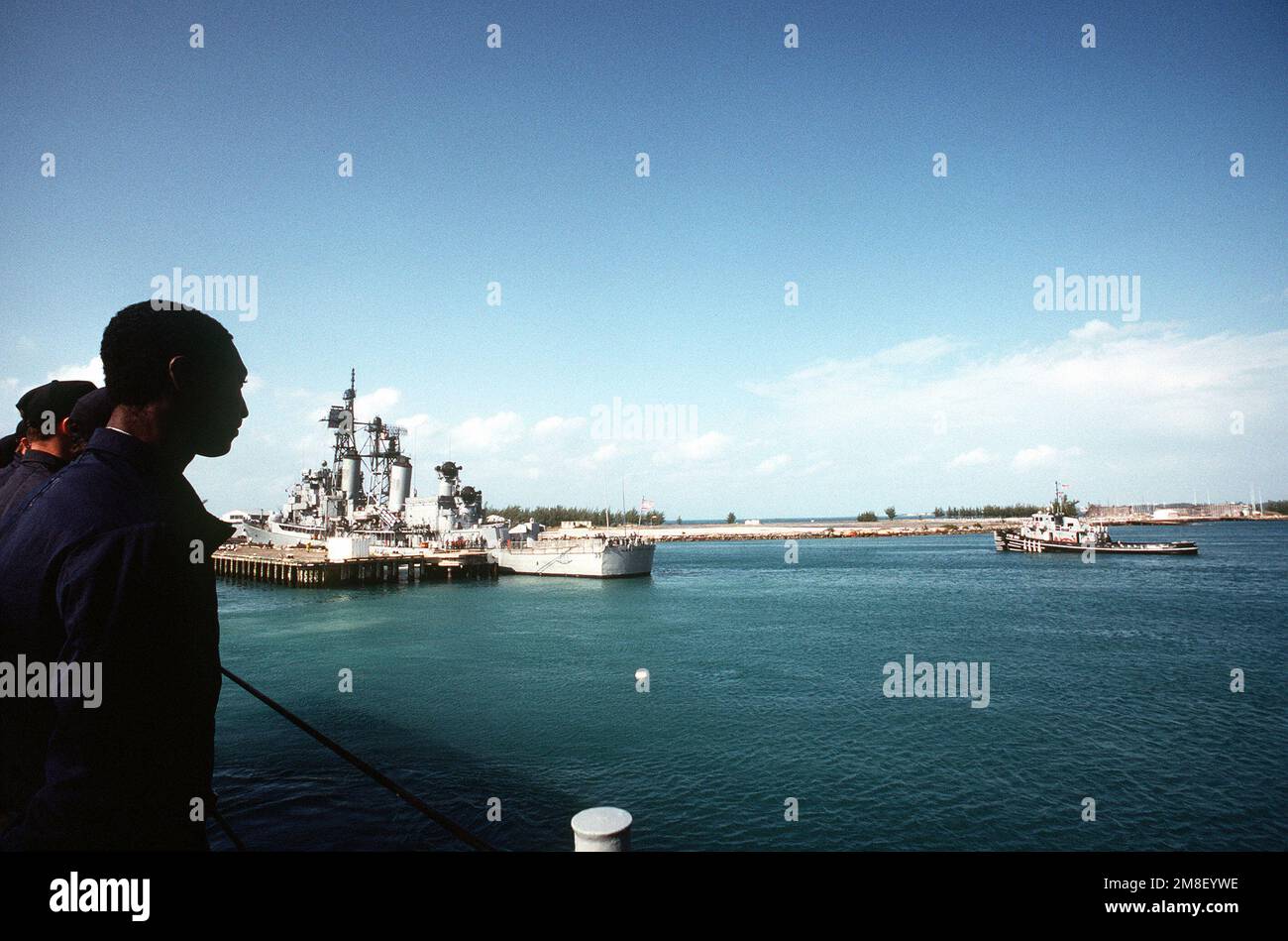 Crew members manning the rails aboard the guided missile frigate USS ...