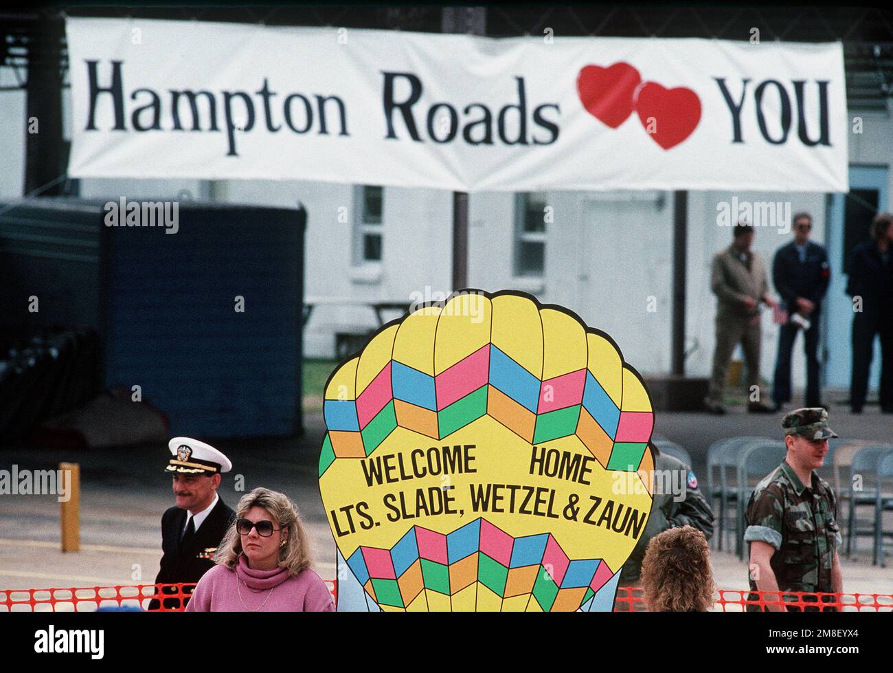 Signs express the sentiments of well-wishers gathered at a ceremony to ...
