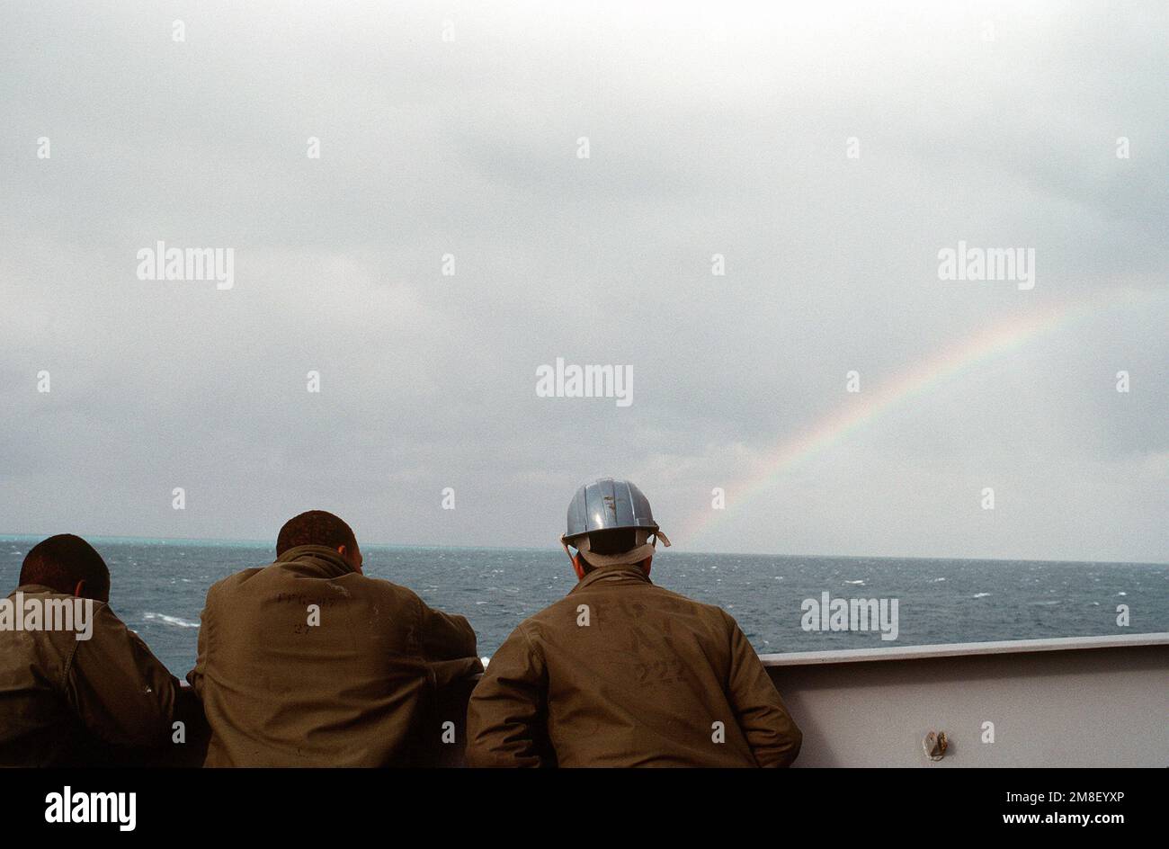 Crewmen aboard the guided missile frigate USS NICHOLAS (FFG-47) look at ...