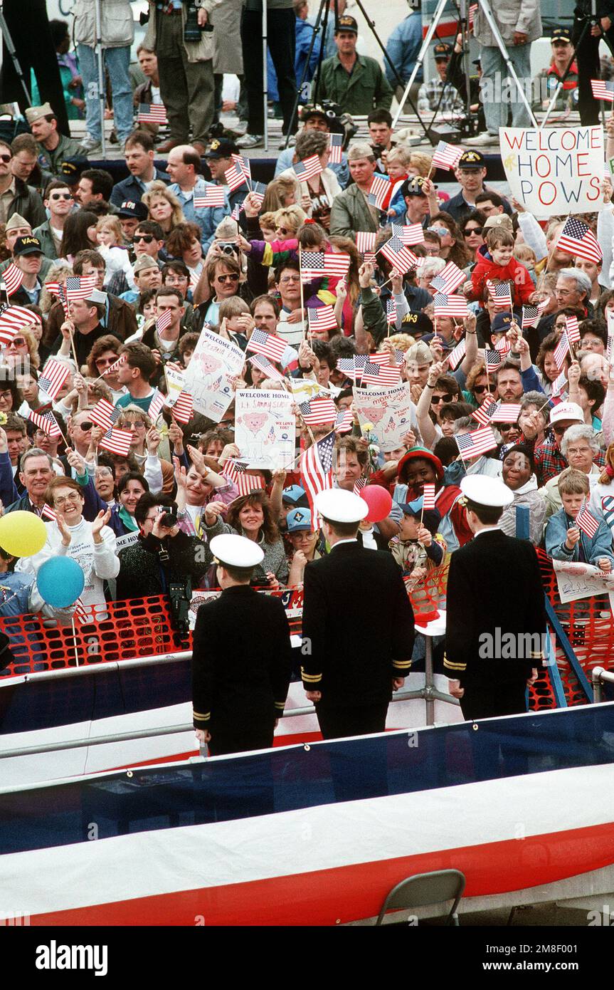 A crowd of well-wishers welcomes LT. Jeffrey Zaun, LT. Lawrence Slade ...