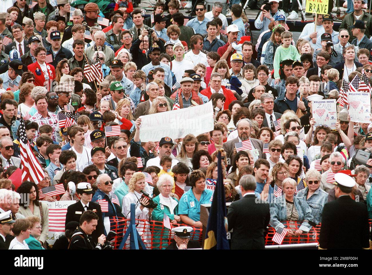 A crowd of well-wishers welcomes LT. Jeffrey Zaun, LT. Lawrence Slade ...