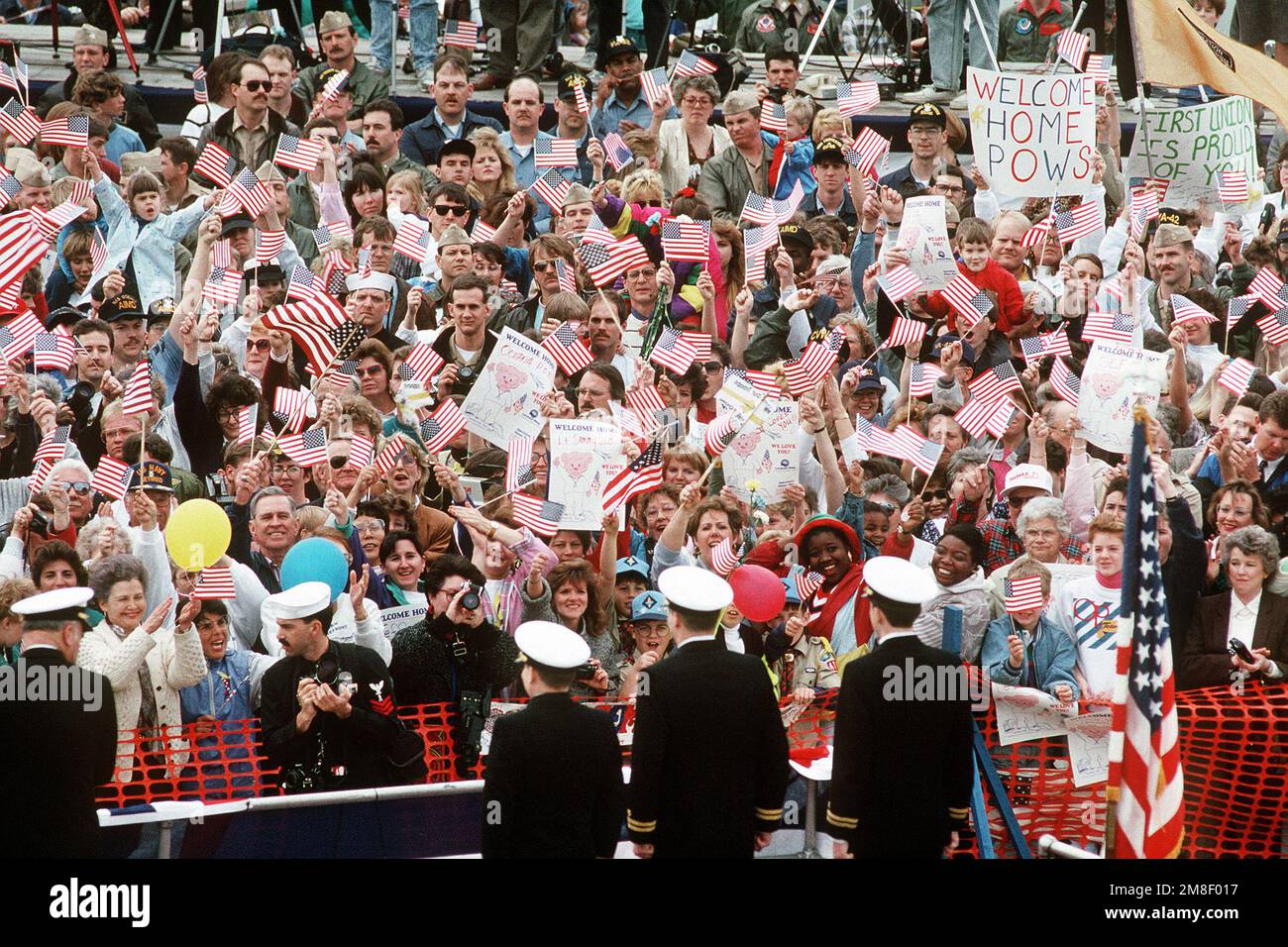 A crowd of well-wishers welcomes LT. Jeffrey Zaun, LT. Lawrence Slade ...
