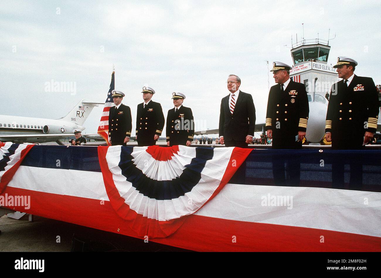 Standing on the platform during a ceremony in their honor are, from ...
