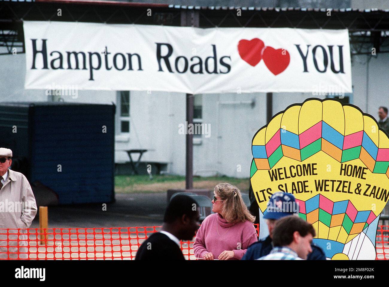 Signs express the sentiments of well-wishers gathered at a ceremony to ...