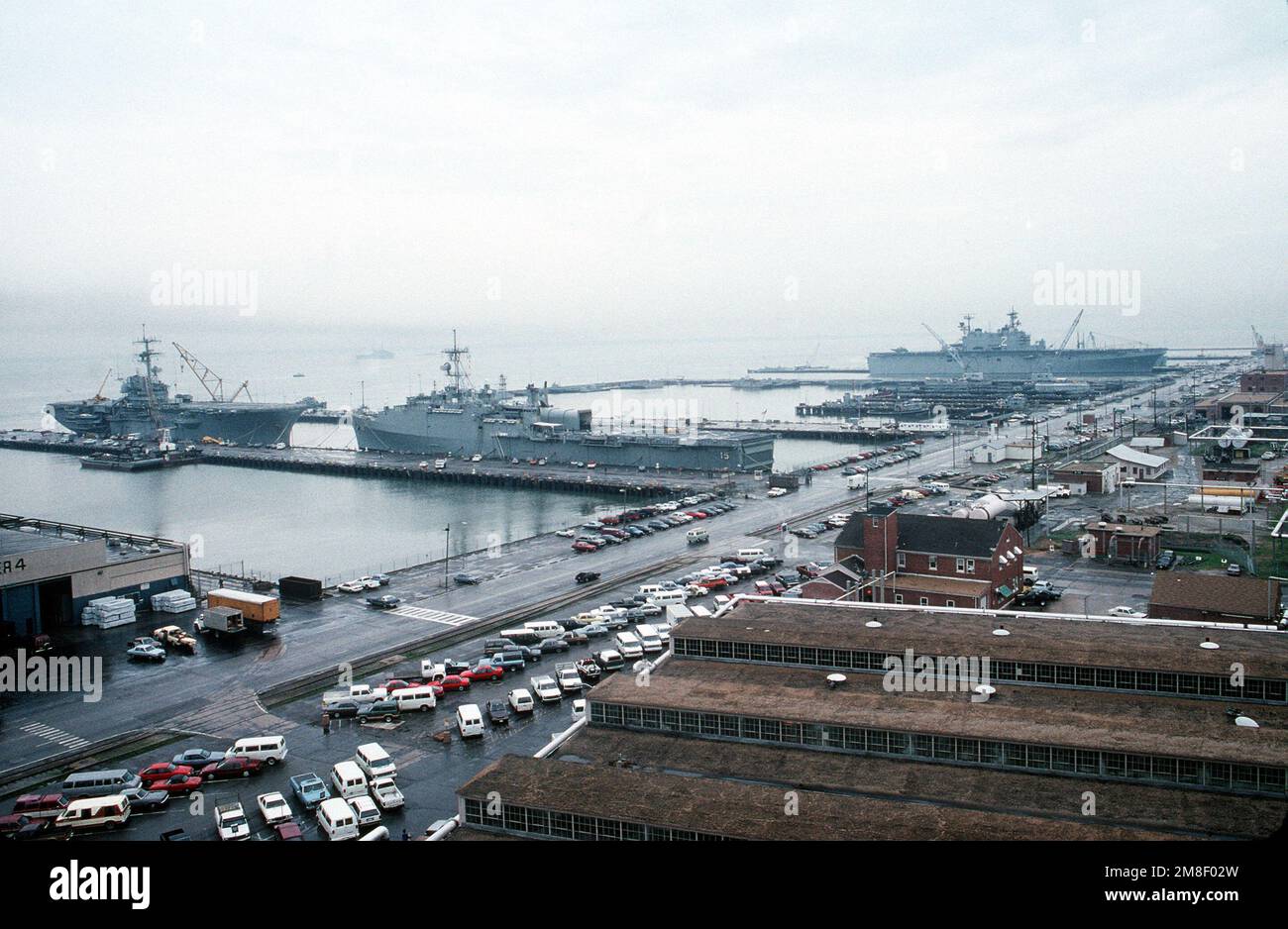 The amphibious assault ship USS INCHON (LPH-12), left, the amphibious ...