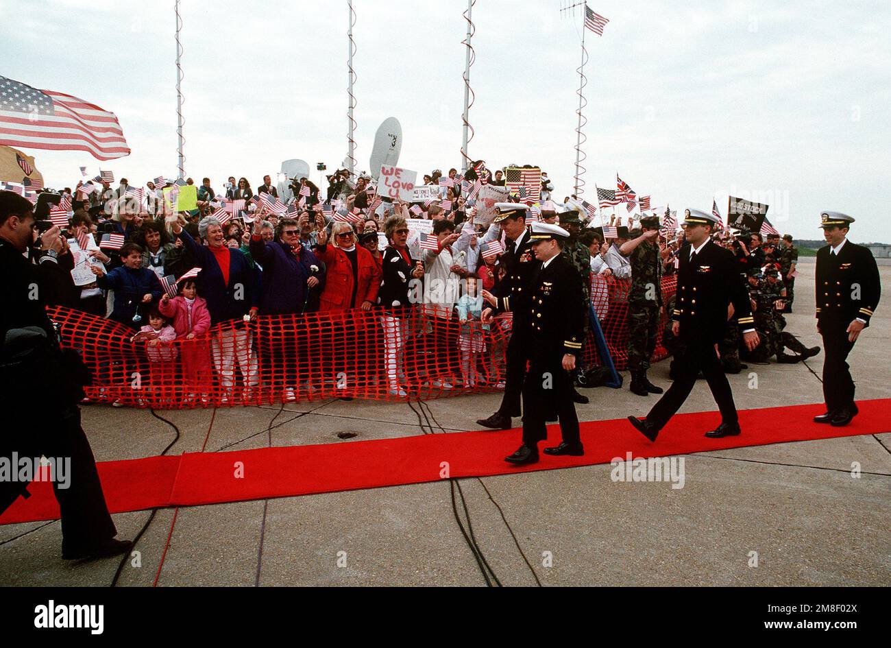 Walking down a red carpet at a ceremony in their honor are, from front ...