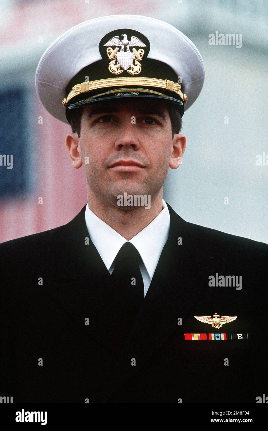 LT. Robert Wetzel stands at attention on the platform during a ceremony ...