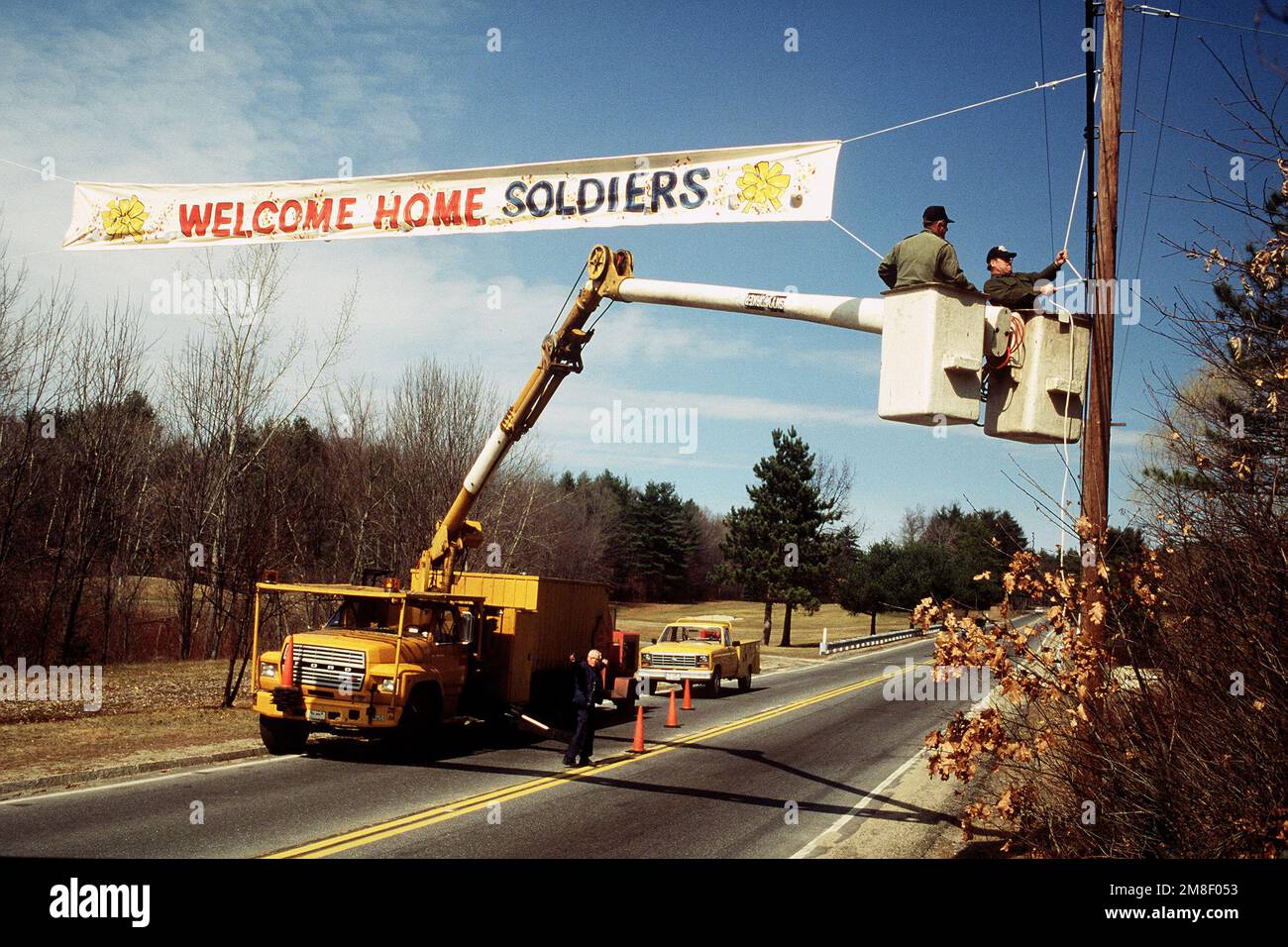 Public works employees hang a banner across the road near Jackson Gate ...
