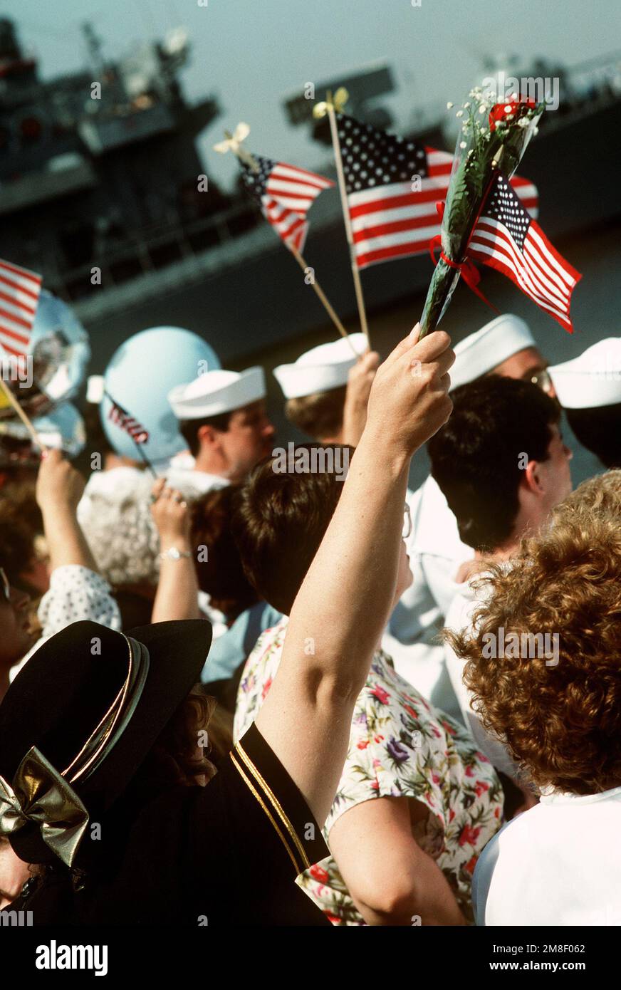 Family and friends crowd a pier during a homecoming celebration for ...