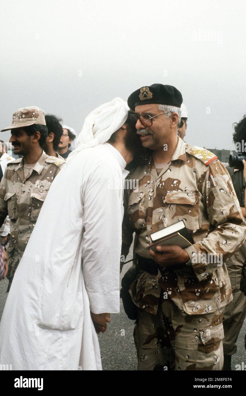 A released Kuwaiti prisoner of war is welcomed home by an officer upon ...