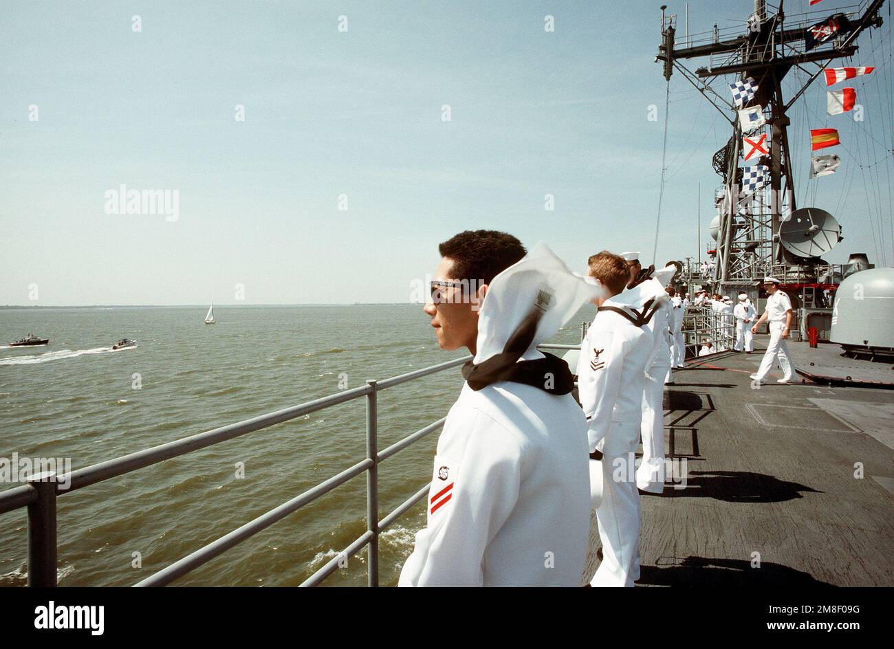 Crew members man the rails aboard the guided missile frigate USS ...