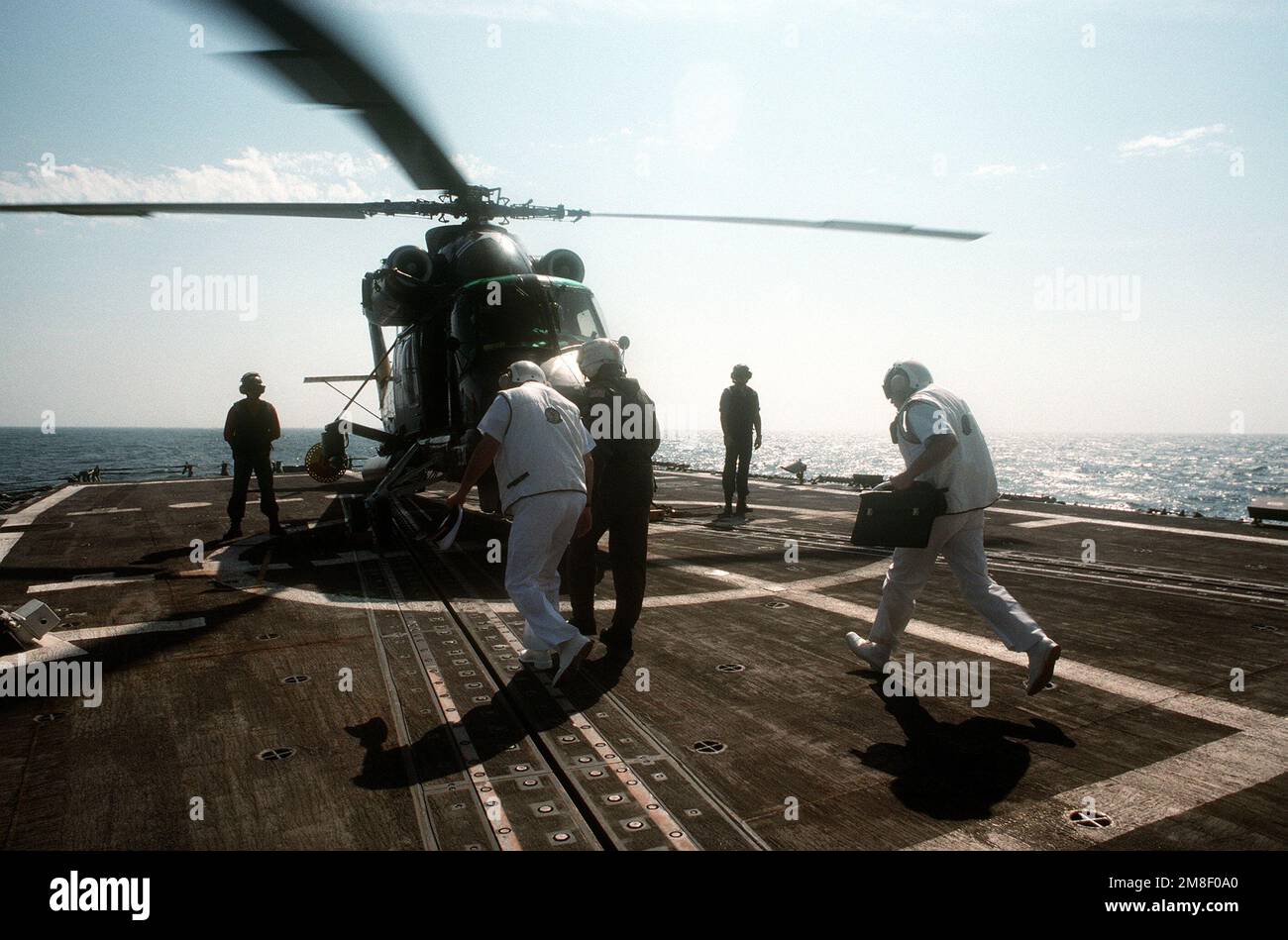 CHIEF of Naval Operations Adm. Frank B. Kelso II and his aide walk ...