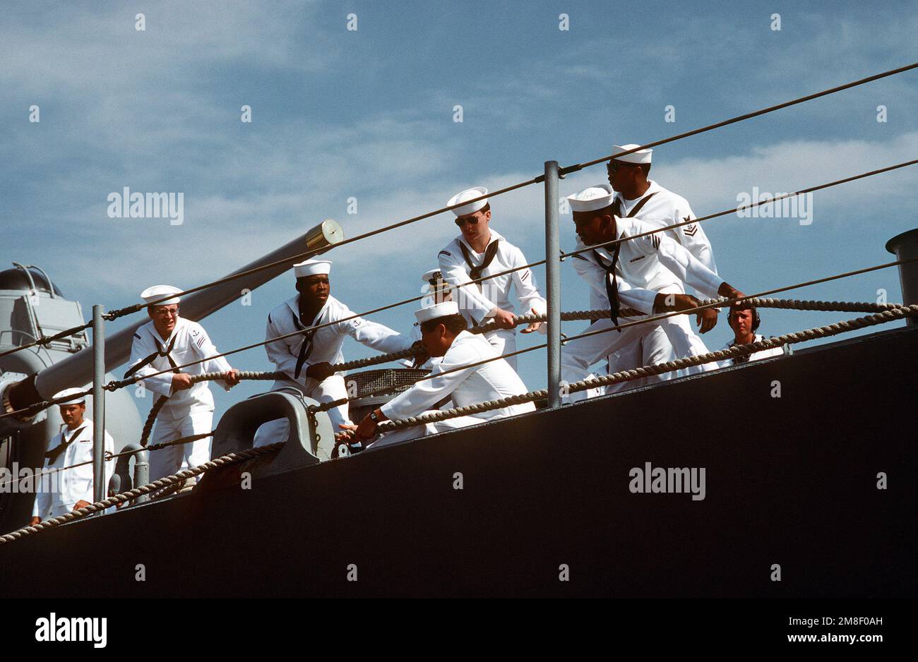 Crewmen aboard the guided missile destroyer USS MACDONOUGH (DDG-39 ...