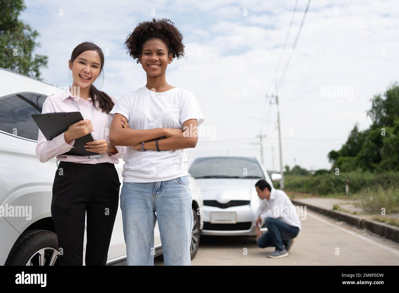 Women drivers Talk to Insurance Agent for examining damaged car and ...