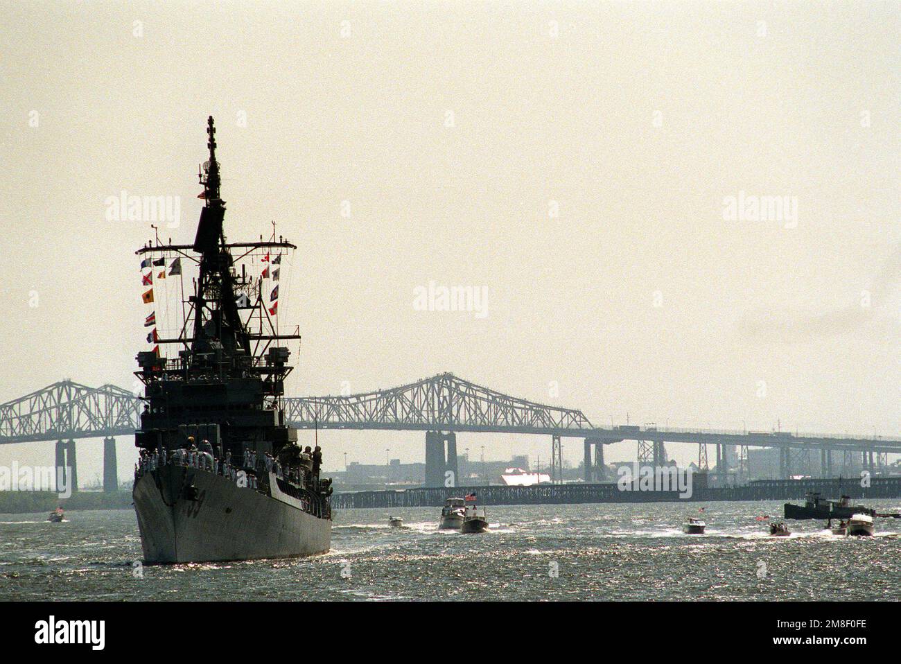 Crew members man the rails as the guided missile destroyer USS ...