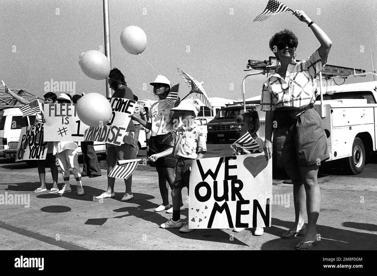 Dependents and base personnel welcome crew members aboard the guided ...