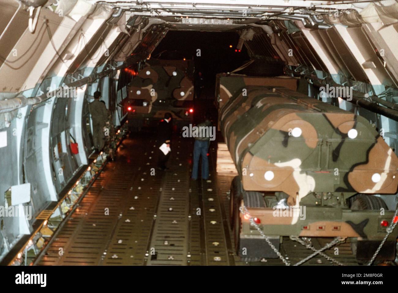 Crewmen guide a ground-launched cruise missile (GLCM) transporter ...