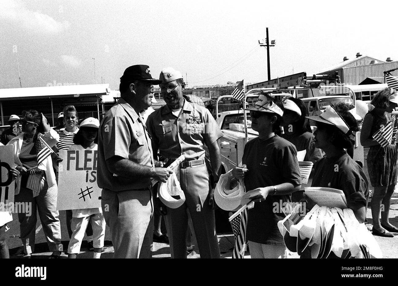 Officers and dependents await the port call of the guided missile ...