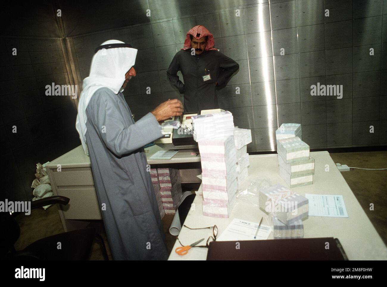 Employees of The Bank of Kuwait and The Middle East prepare to issue ...