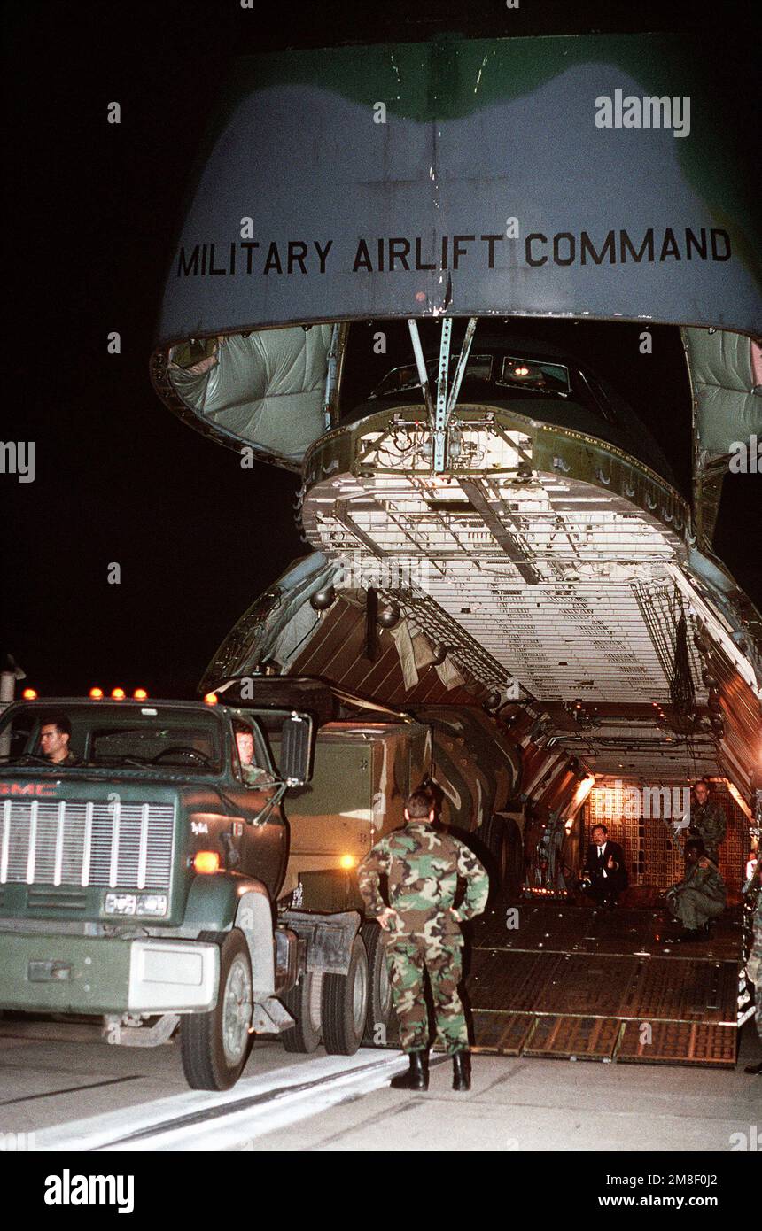 Crewmen of a 436th Military Airlift Wing C-5 Galaxy aircraft help load ...