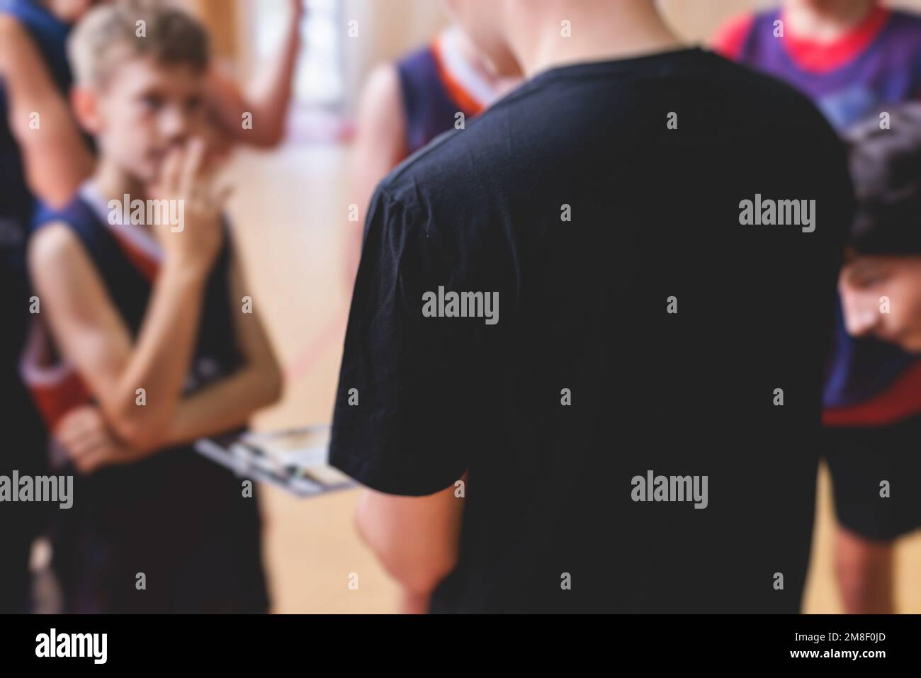 Junior young basketball team with a coach, group of kids children team ...