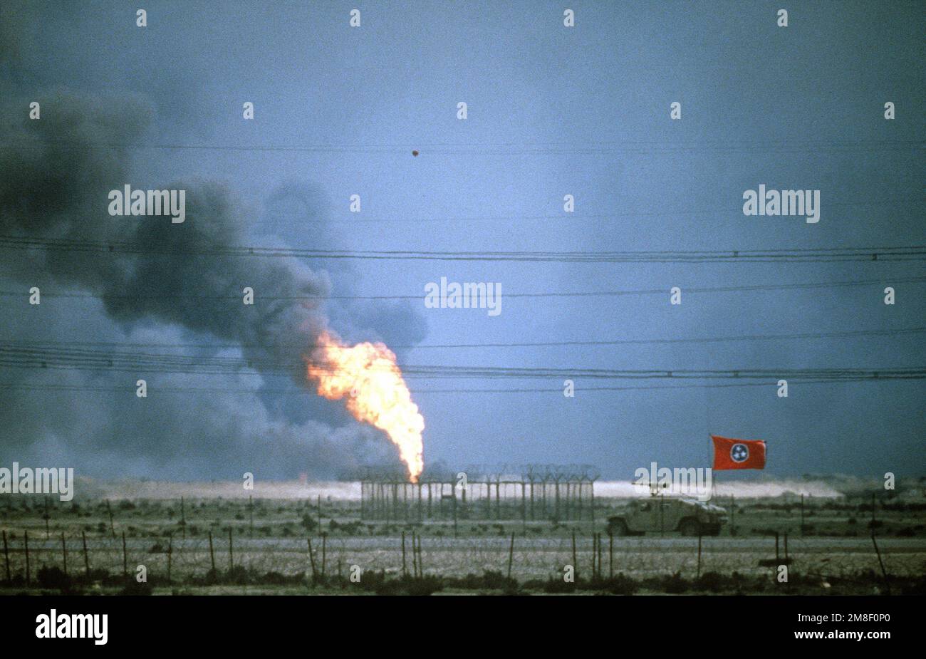 An oil well fire rages out of control after being set by occupying ...