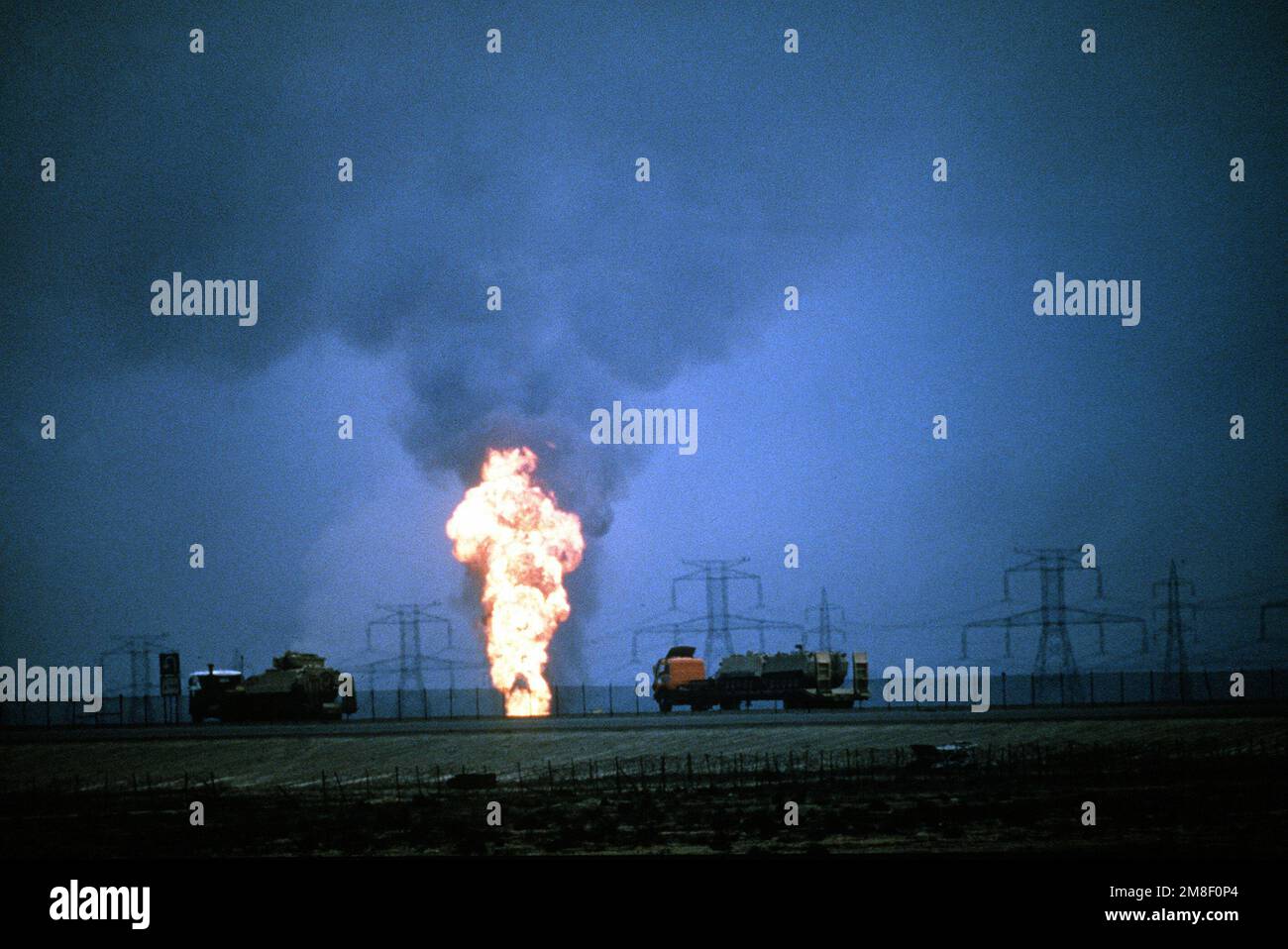 An oil well fire rages out of control after being set by occupying ...