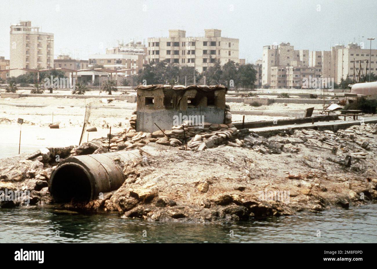 Sand bags surround an abandoned guard post on the beach in Kuwait City ...