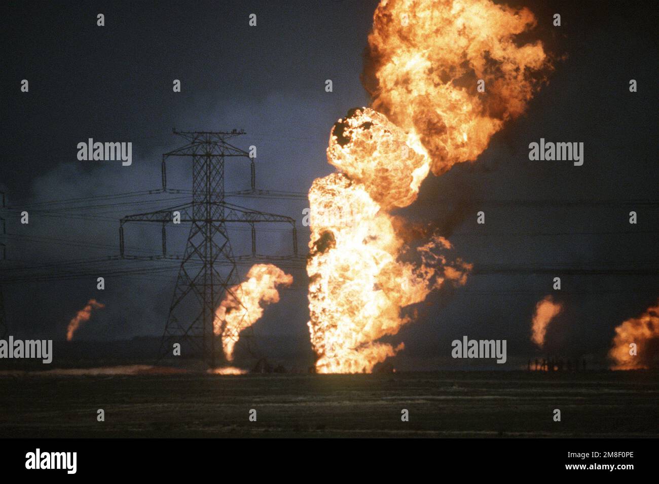 Oil well fires blaze out of control outside Kuwait City. The wells were ...