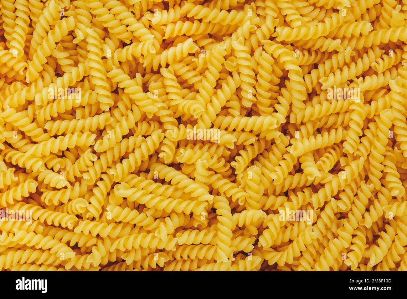 Raw dry fusilli pasta, food background texture, top view Stock Photo ...