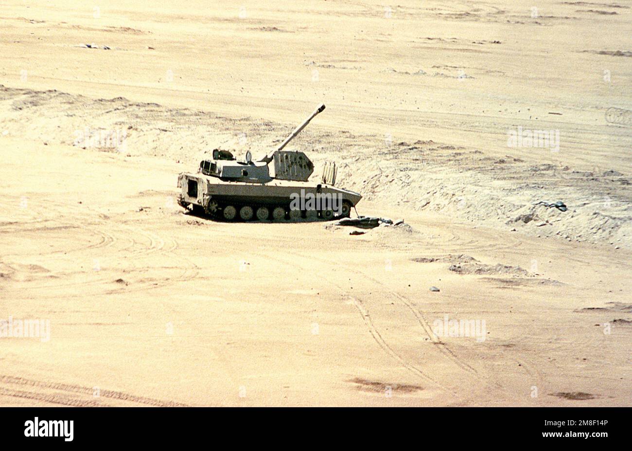 An Iraqi M-1974 122mm self-propelled howitzer lies stranded in the ...