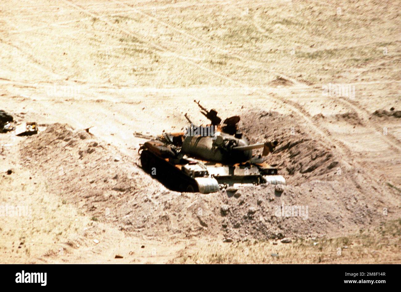 A T-55 main battle tank stands in the desert after being hit by Allied ...