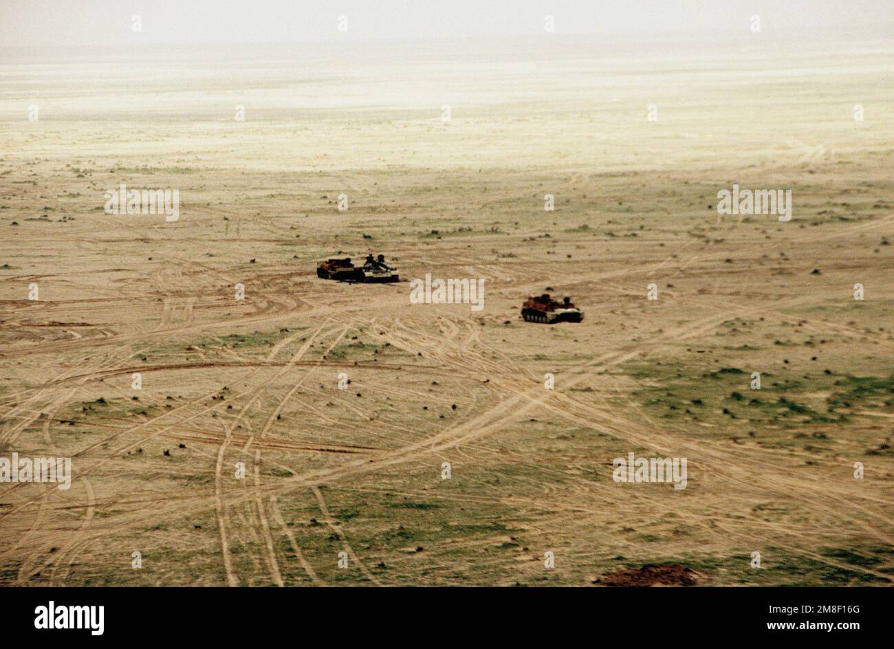 An Iraqi T-55 main battle tank and two MT-LB armored personnel carriers ...