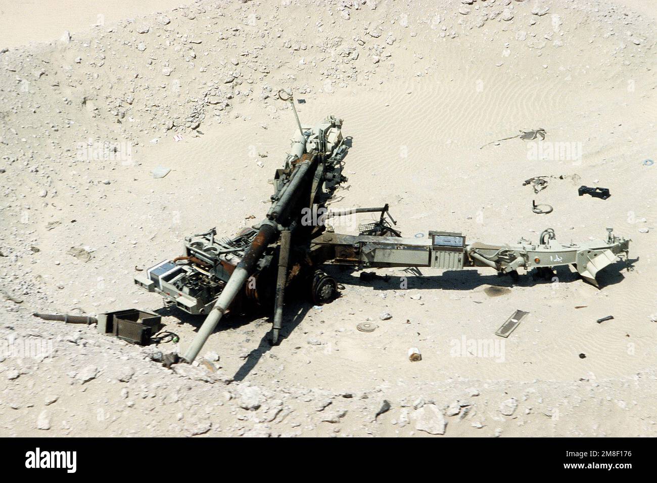 A demolished Iraqi artillery piece lies in the sand in the aftermath of ...