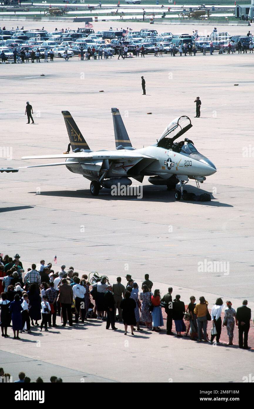The crowd watches as the pilot of a Fighter Squadron 32 (VF-32) F-14A ...