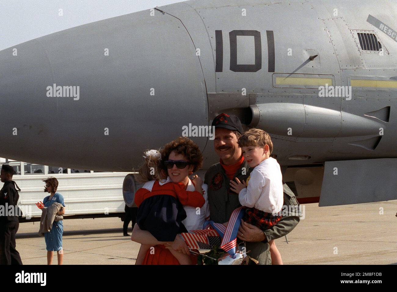 A Fighter Squadron 74 (VF-74) pilot and his family stand beside an F ...