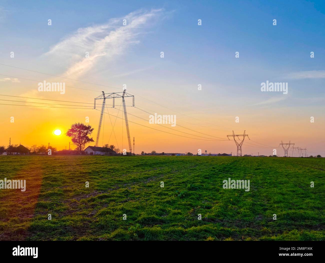 High voltage electric poles, rural landscape with power pylons in a row ...