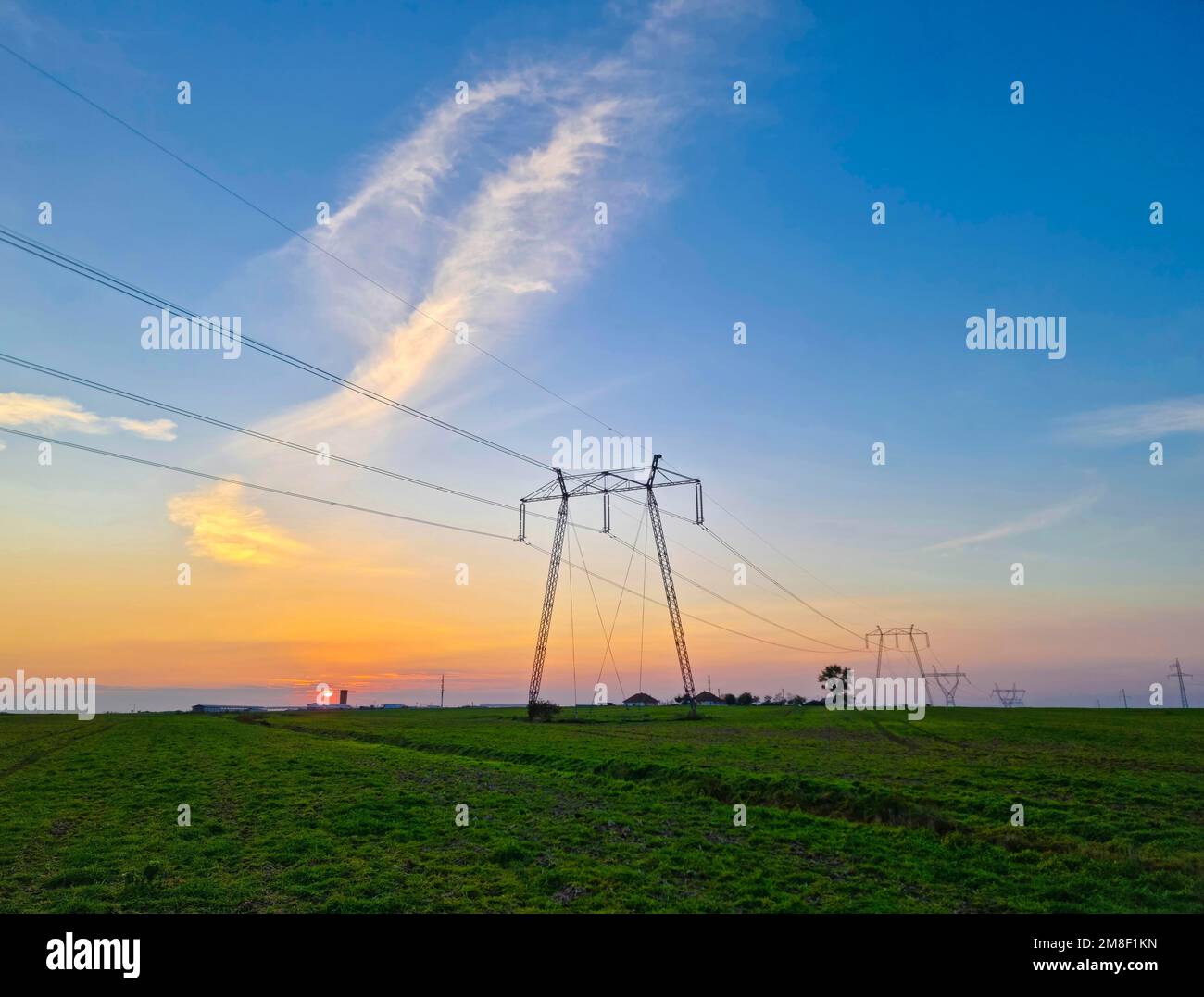 High voltage electric poles, rural landscape with power pylons in a row ...