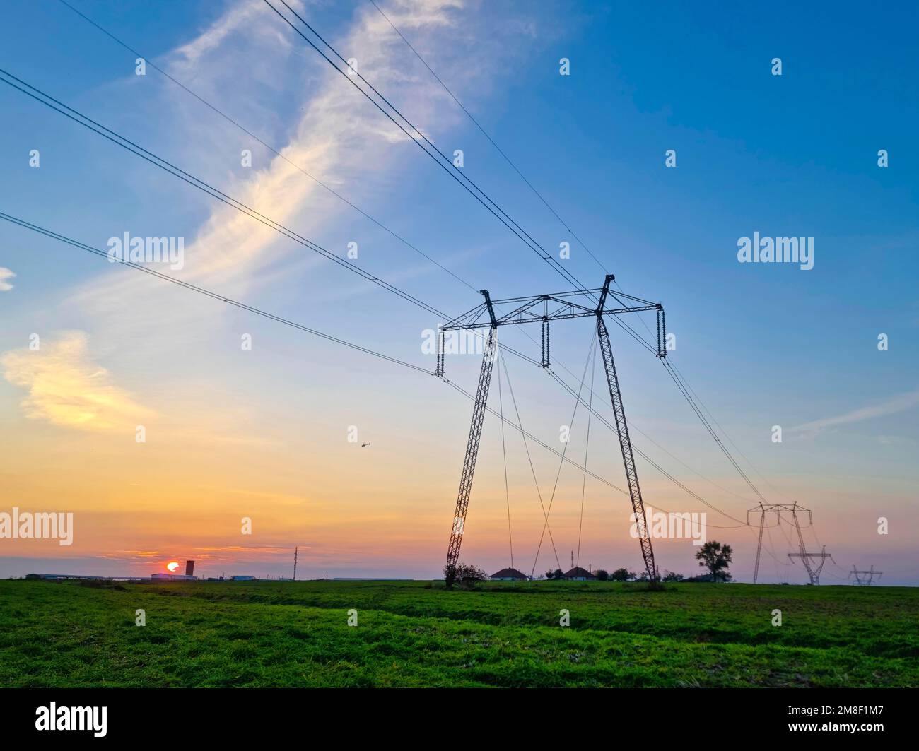 High voltage electric poles, rural landscape with power pylons in a row ...