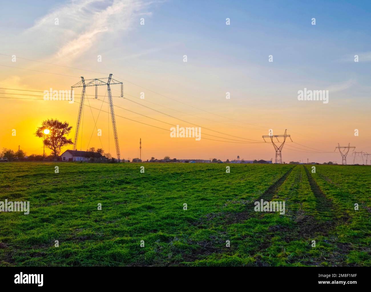 High voltage electric poles, rural landscape with power pylons in a row ...