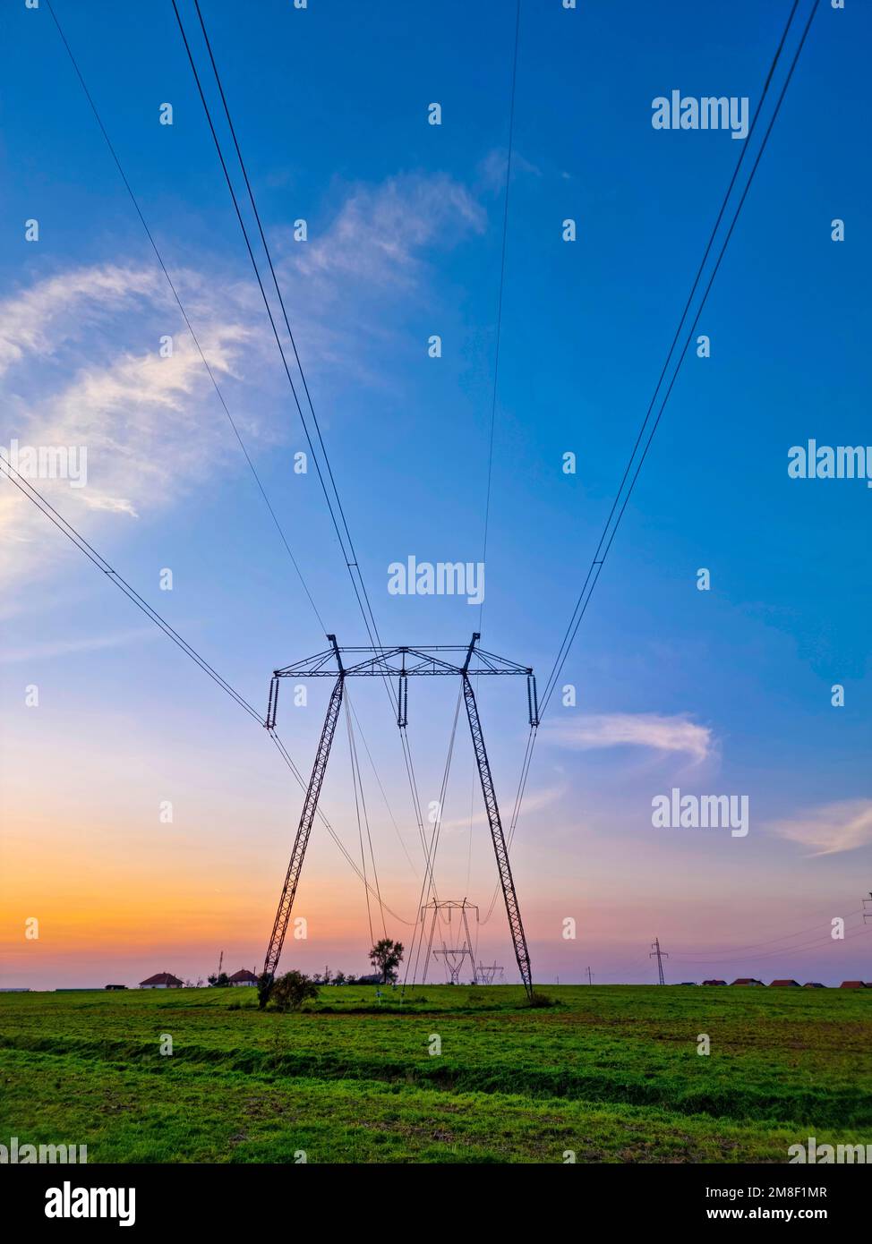 High voltage electric poles, rural landscape with power pylons in a row ...