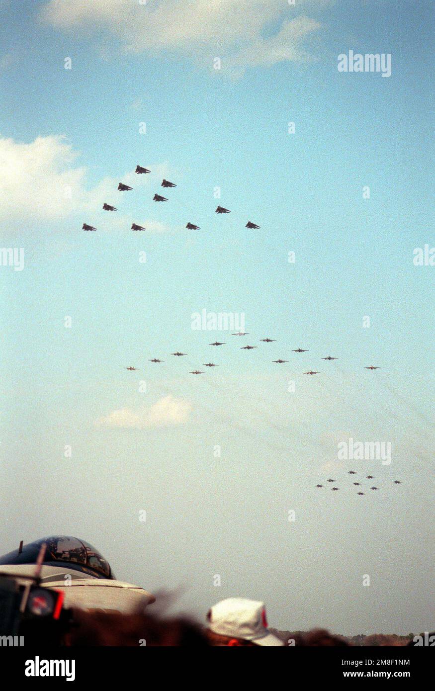 A formation of A-6E Intruder aircraft flies between two formations of F ...